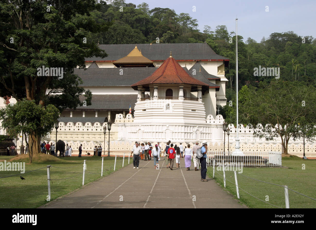 People walking towards the Temple of the Tooth, a sacred buddhist ...
