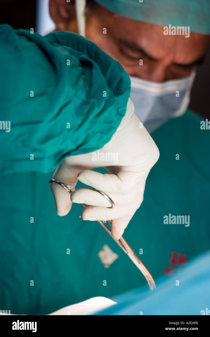 A surgeon cuts into his patient Stock Photo - Alamy