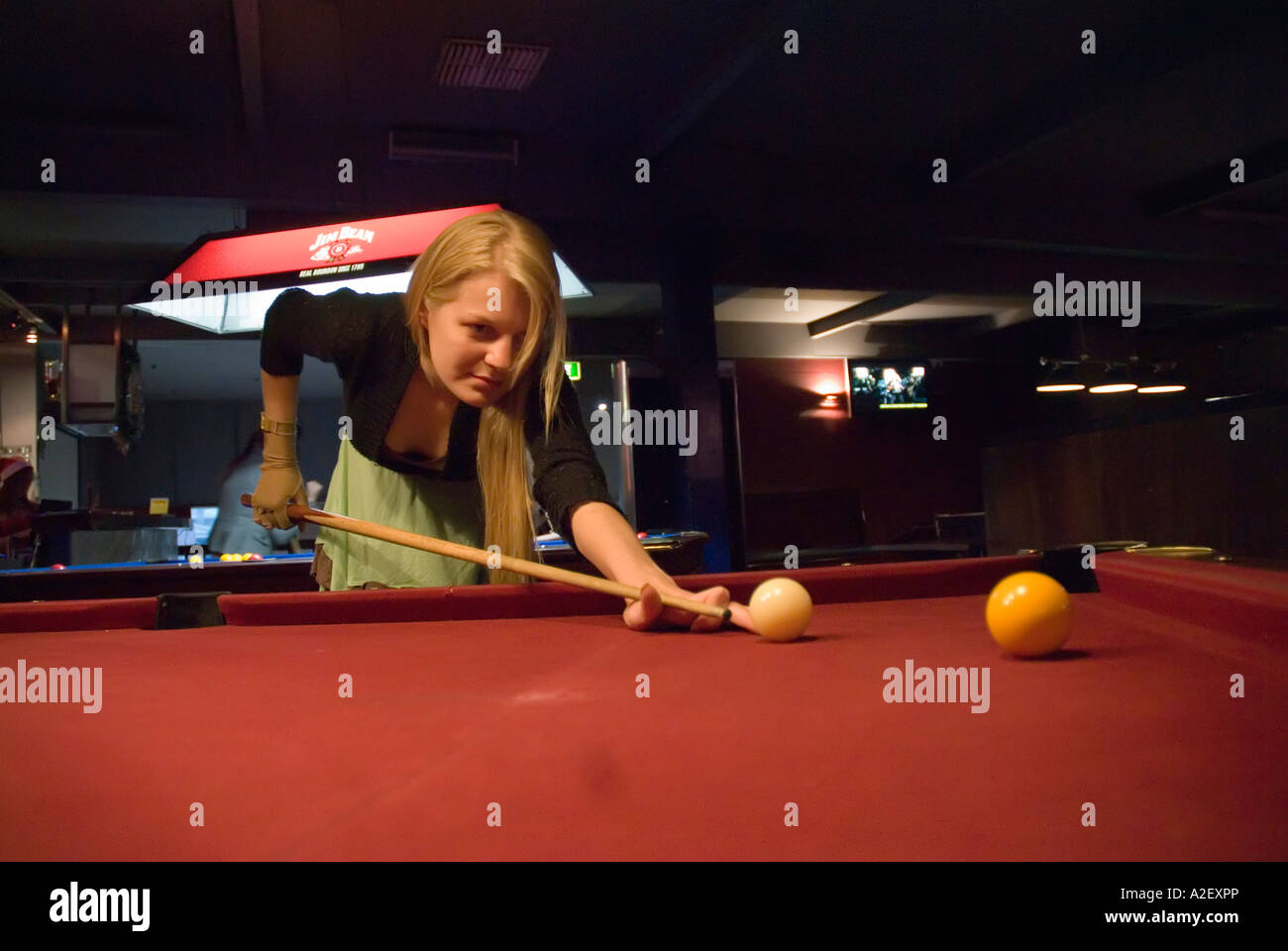 Teenage girl playing pool Stock Photo - Alamy