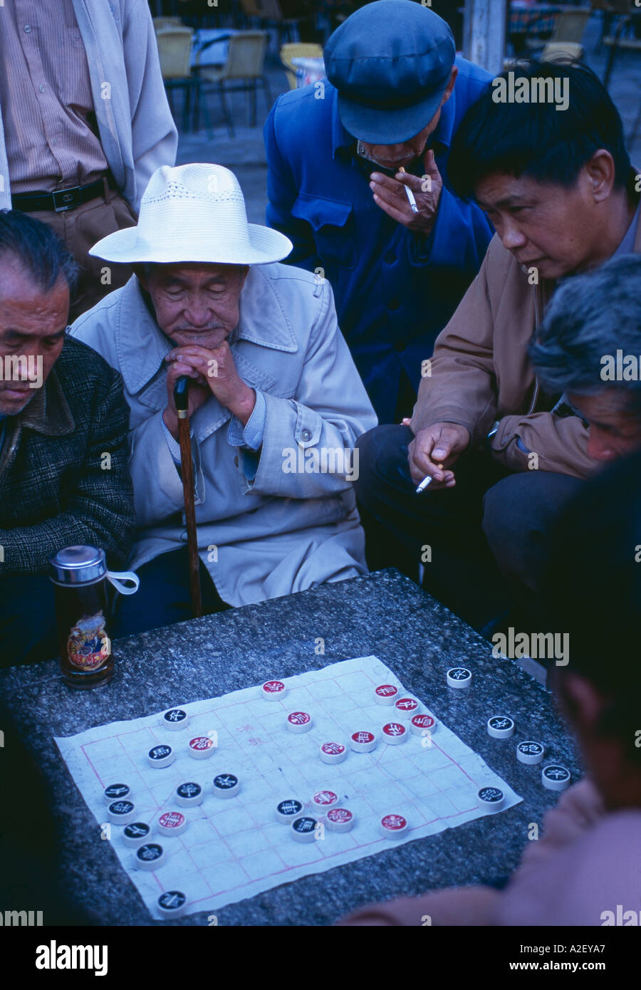 Chinese men playing boardgame in street Dali Yunnan Province China ...