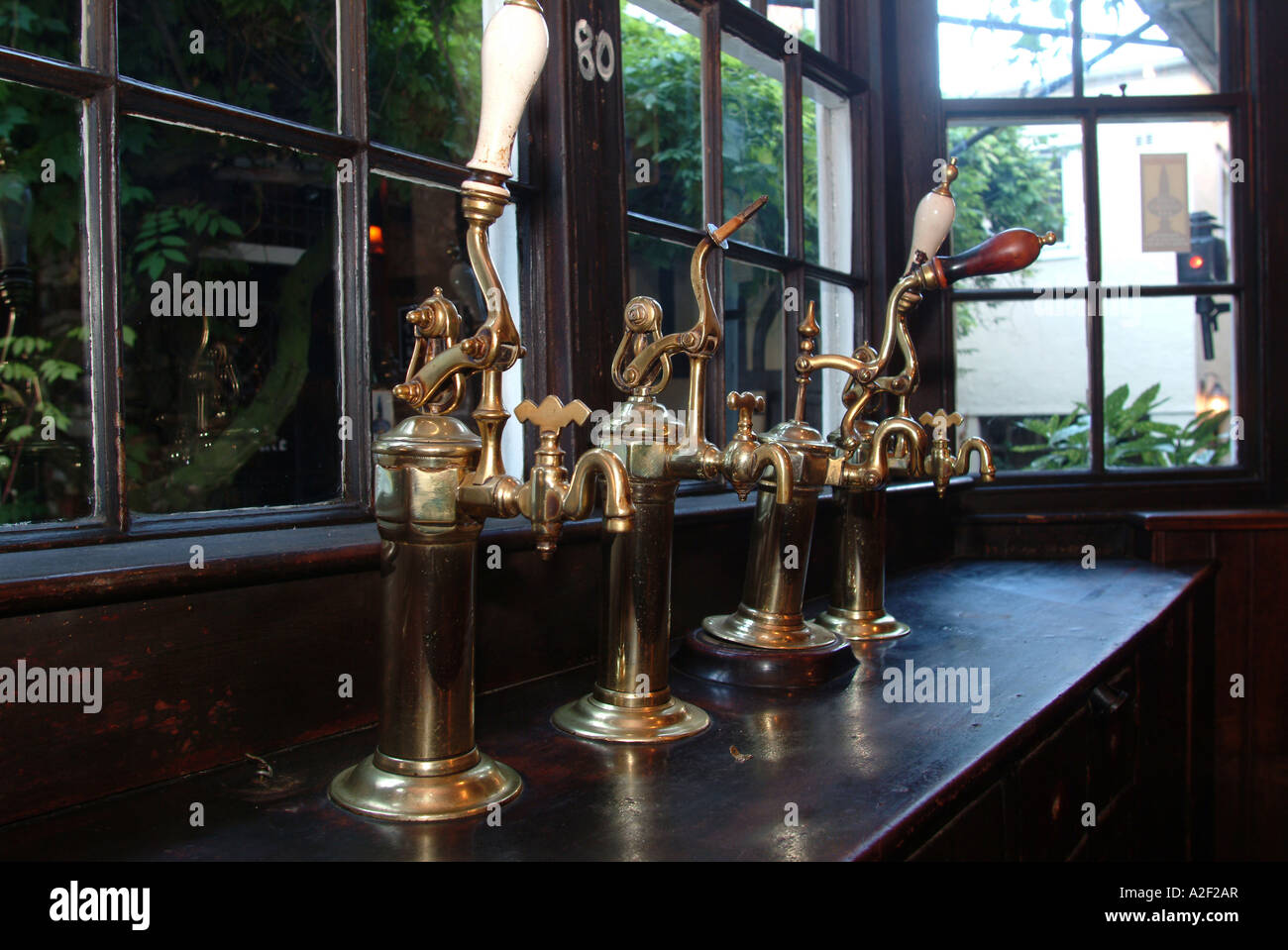 Old-fashioned beer pumps in public house in England, UK Stock Photo - Alamy