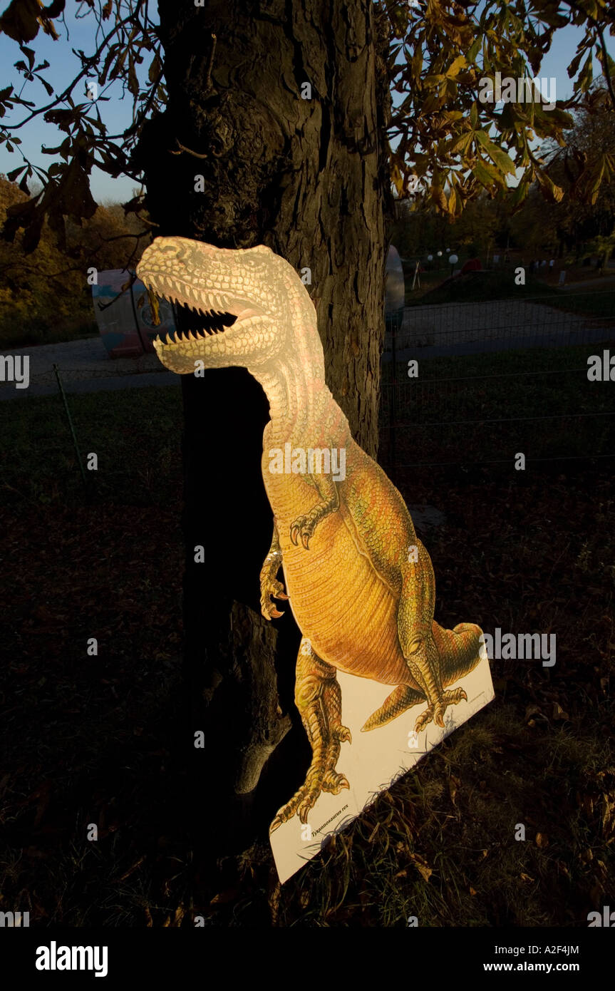 Dinosaur under tree Stock Photo - Alamy