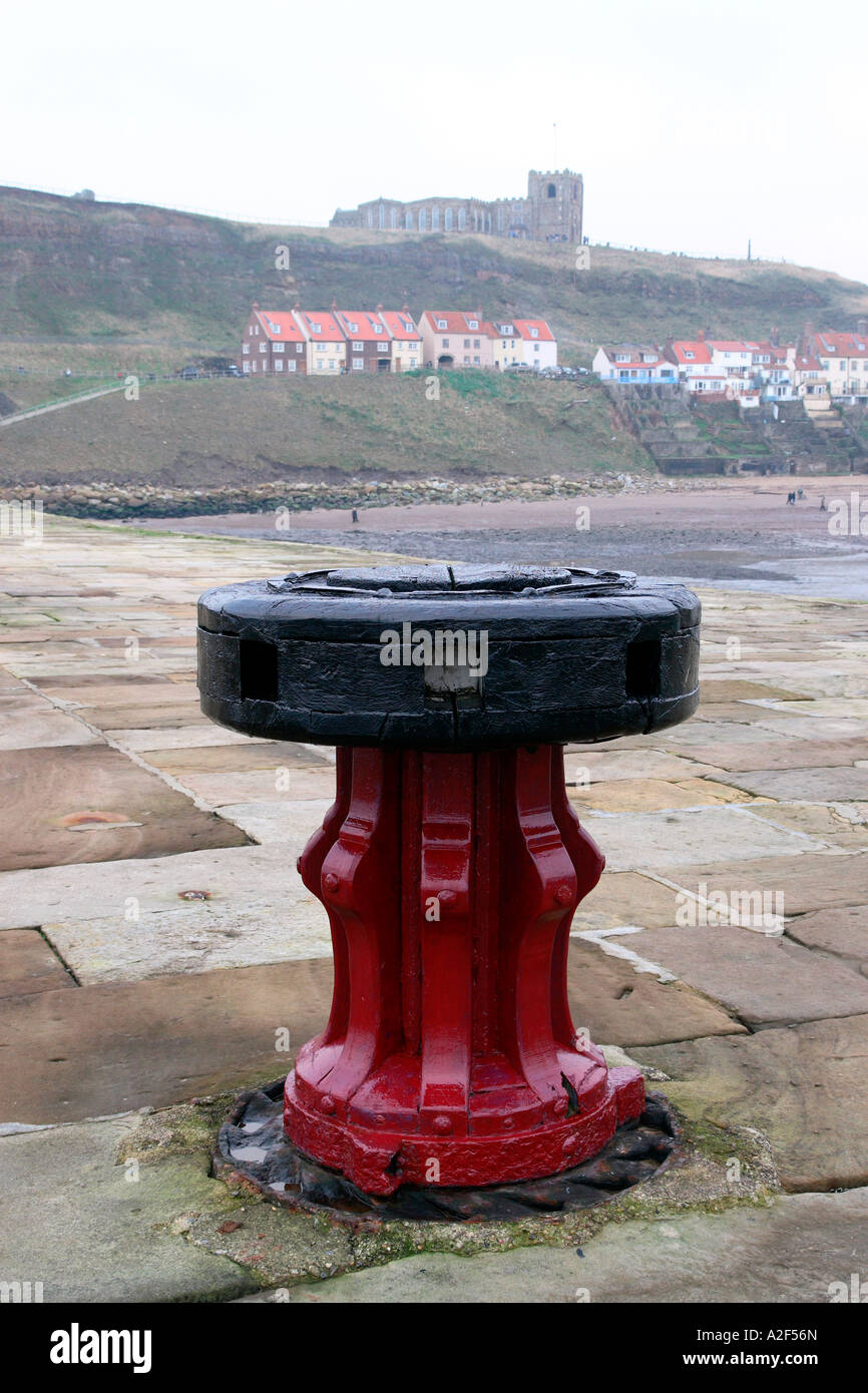 A capstan on Whitby harbour breakwater overlooked by the historic St ...