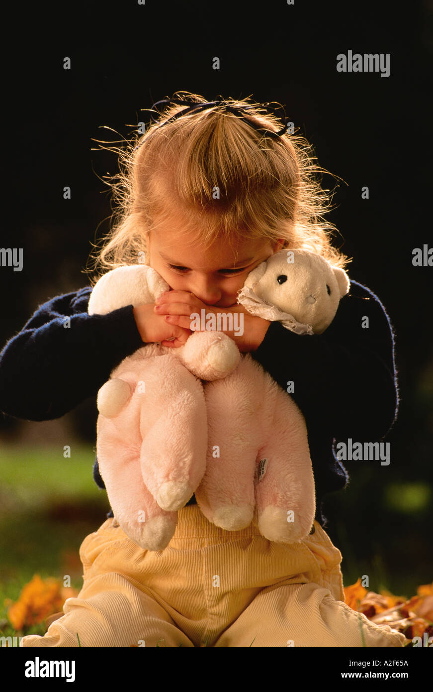 GIRL HUGGING TOYS Stock Photo - Alamy