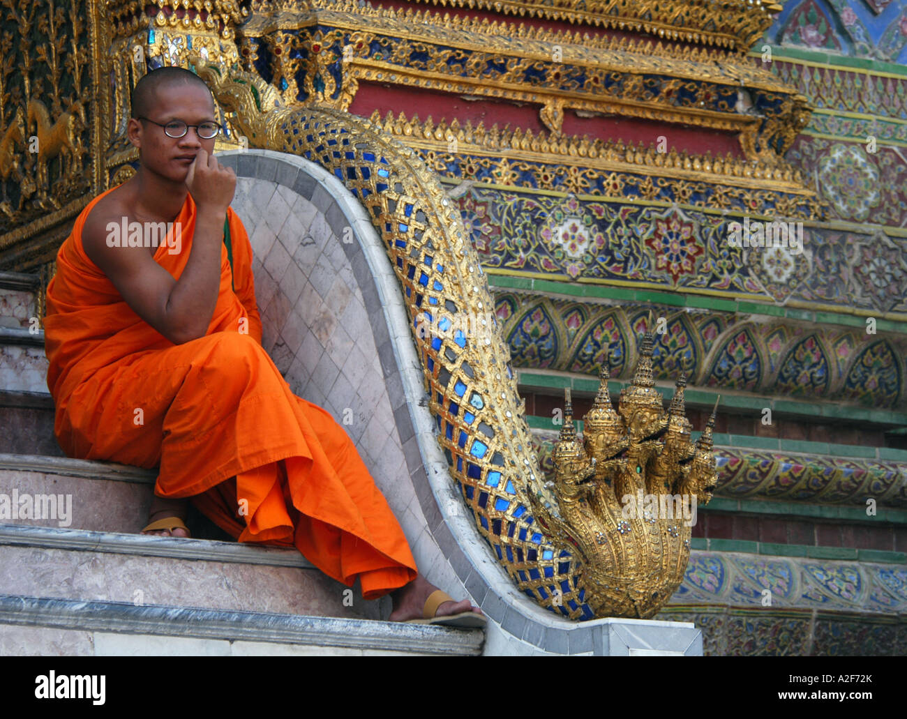 Buddhist monk resting in front of the Royal Palace in Bangkok, Thailand ...