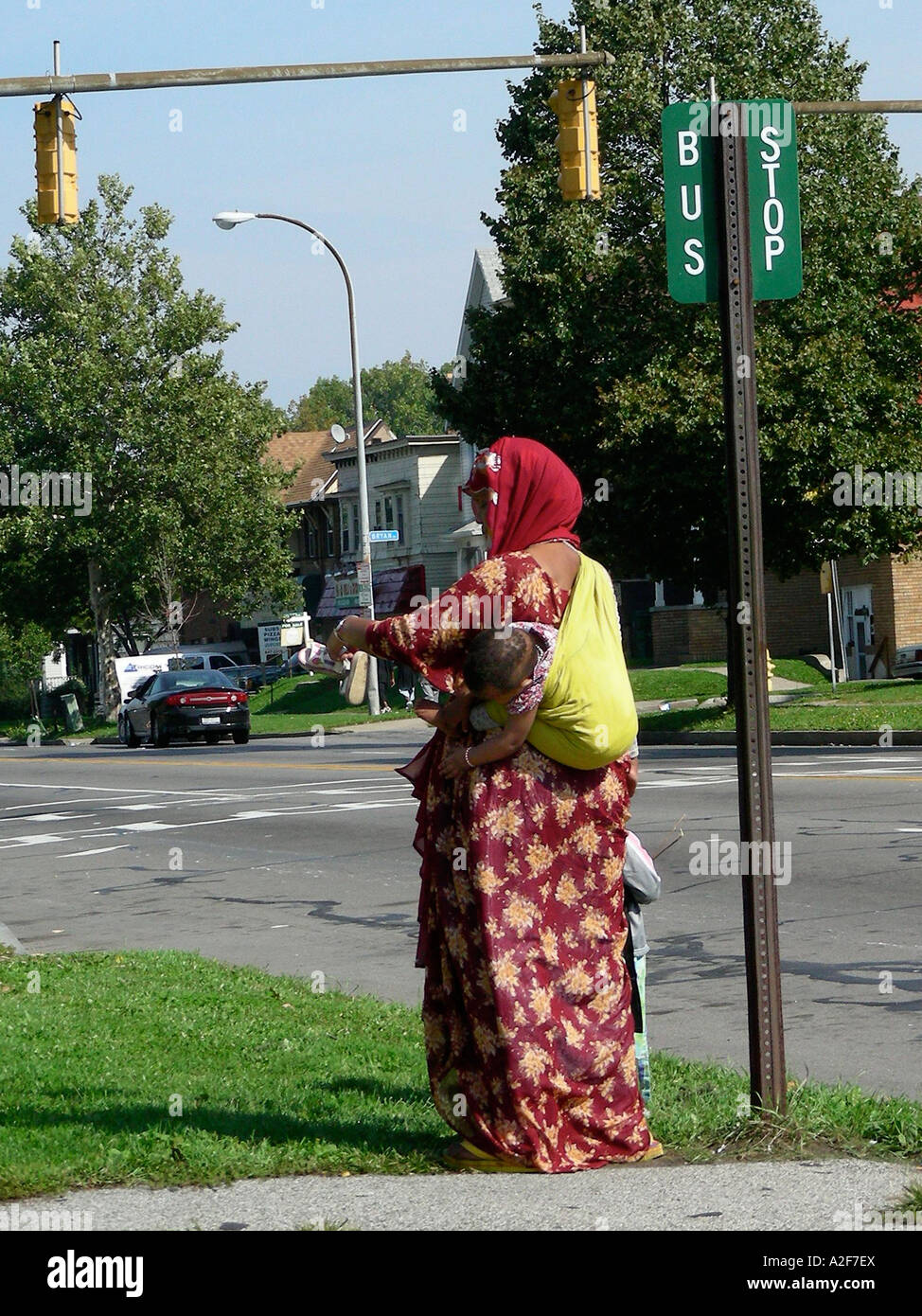 Woman and baby at bus stop Stock Photo - Alamy