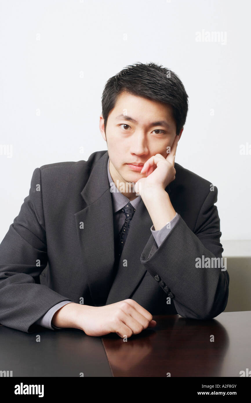 Portrait of a businessman thinking Stock Photo - Alamy