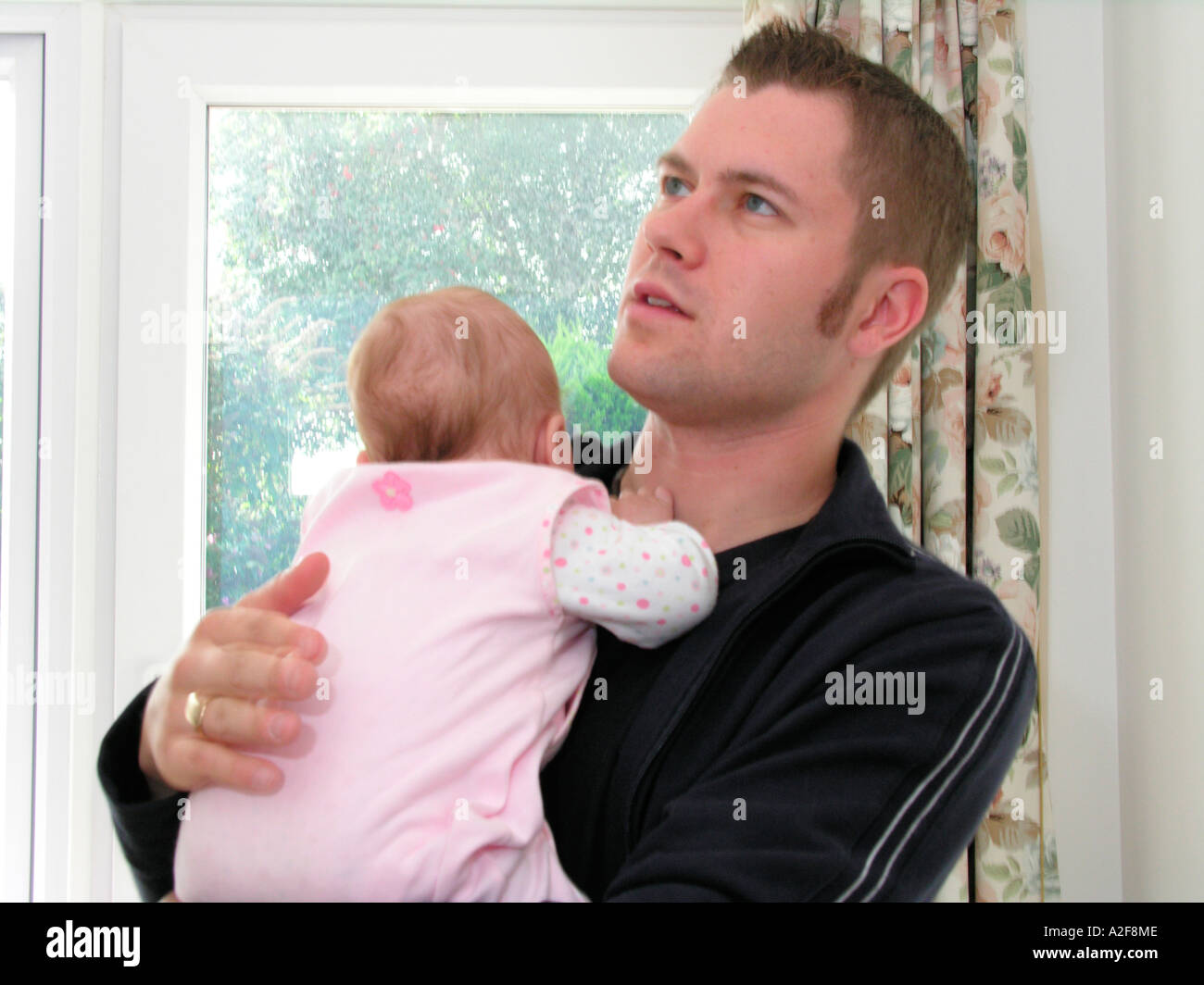 proud father cuddling and pacifying his baby daughter Stock Photo - Alamy
