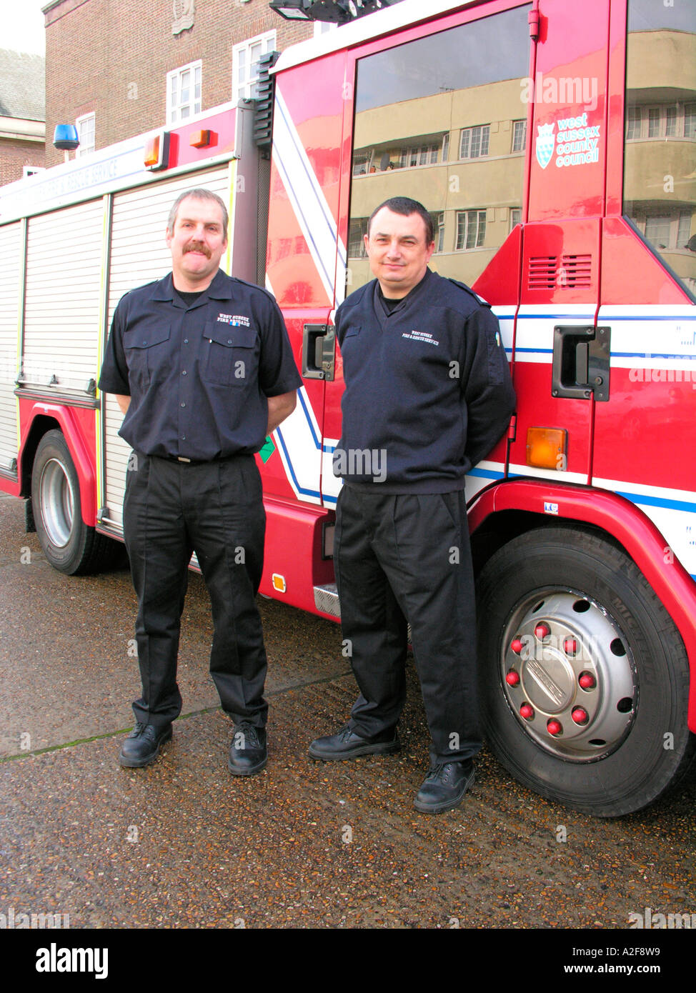 firemen standing next to West Sussex Fire and Rescue Service vehicle in ...