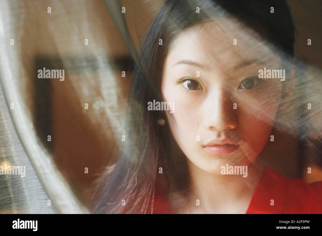 Woman behind a curtain hi-res stock photography and images - Alamy