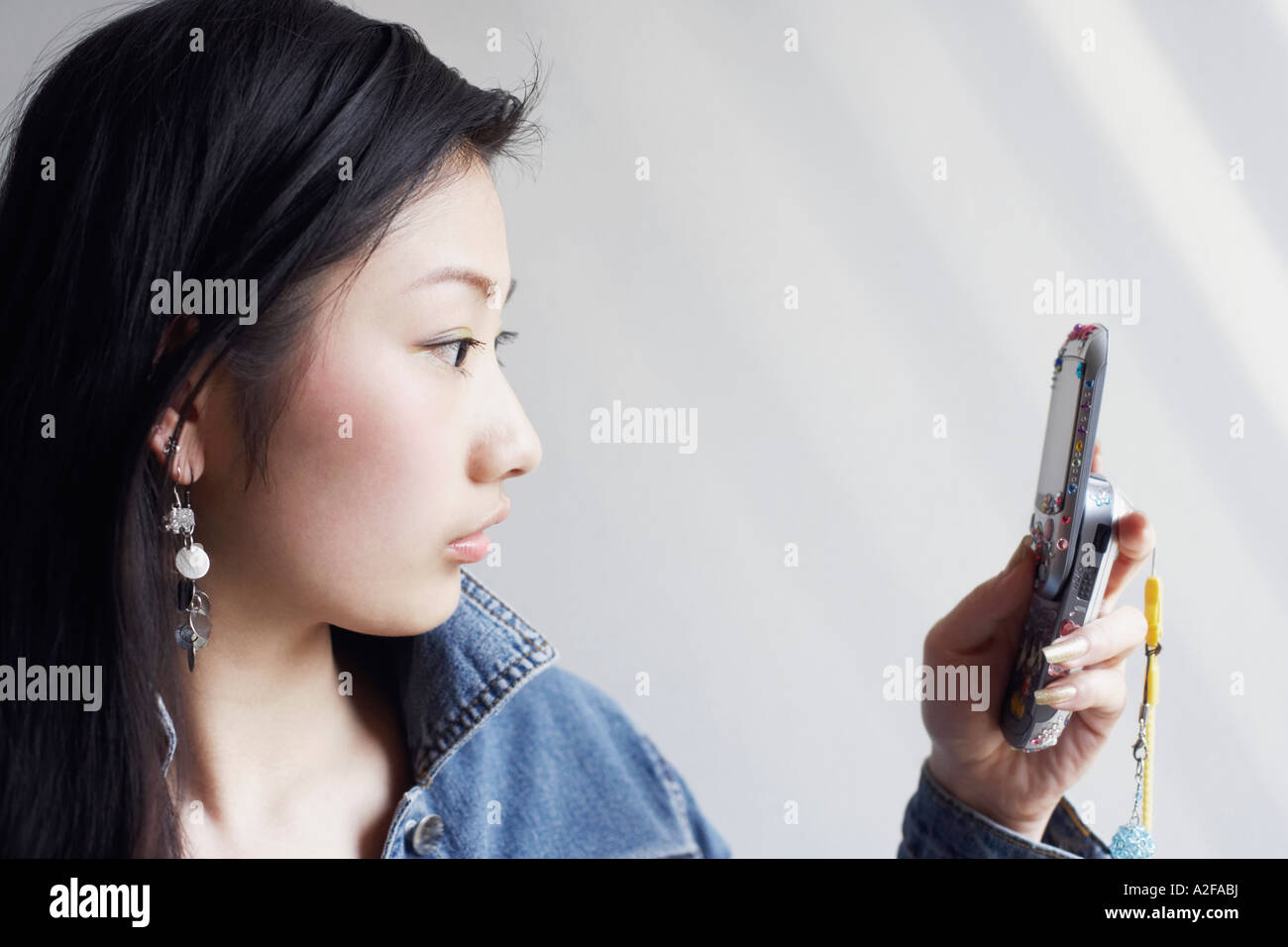 Young ladies using phone holding hi-res stock photography and images ...
