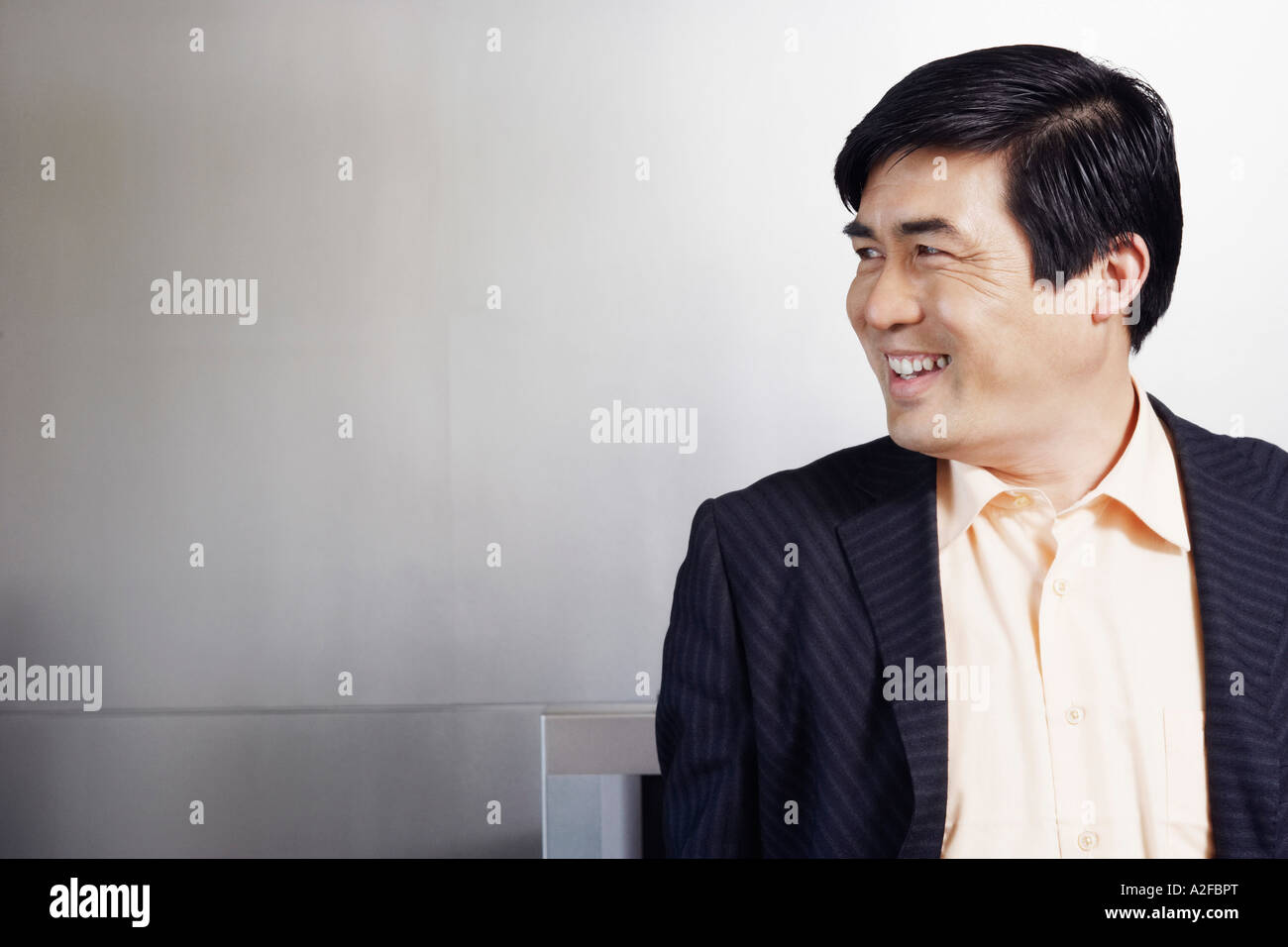 Close-up of a businessman looking sideways smiling Stock Photo - Alamy
