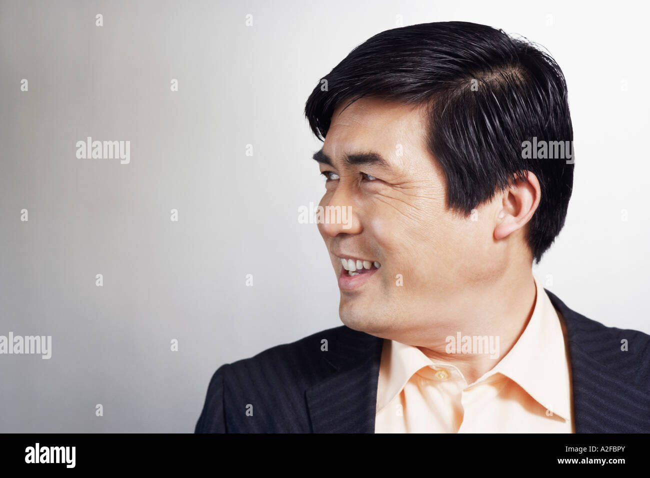 Close-up of a businessman looking sideways smiling Stock Photo - Alamy