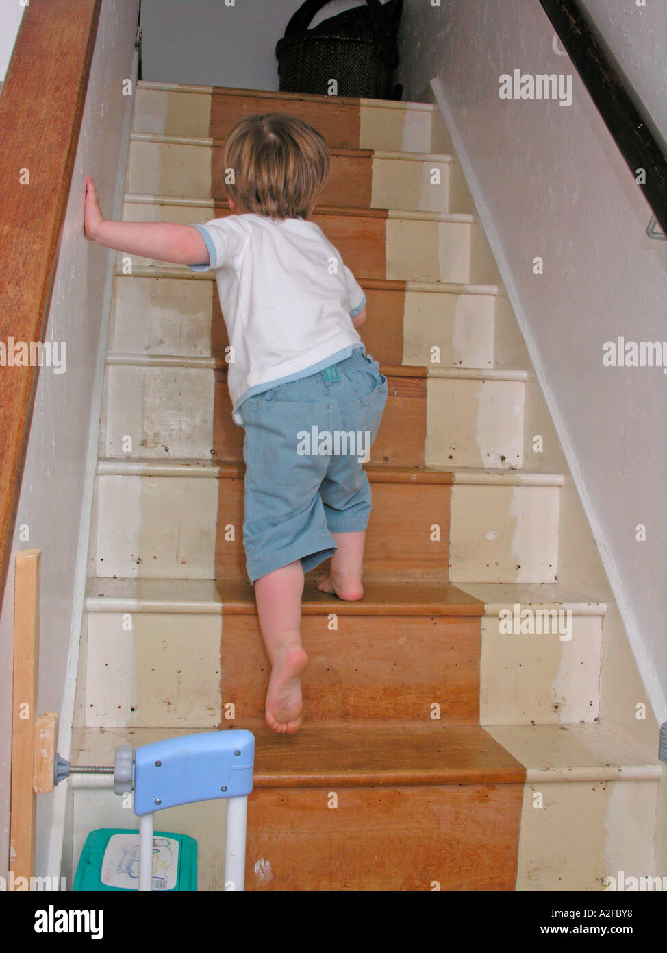 toddler clambering up stairs Stock Photo - Alamy