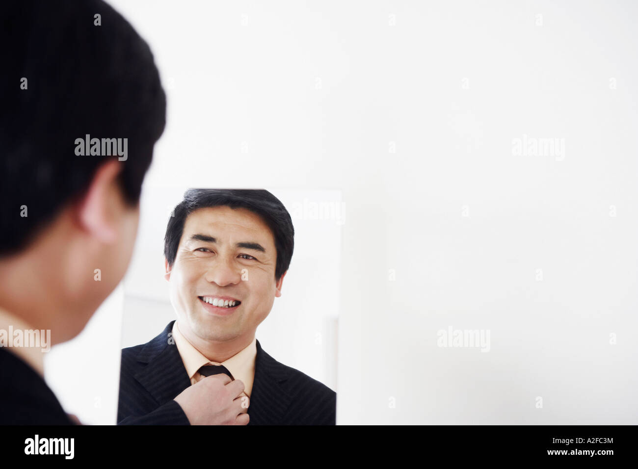 Rear view businessman looking mirror hi-res stock photography and ...