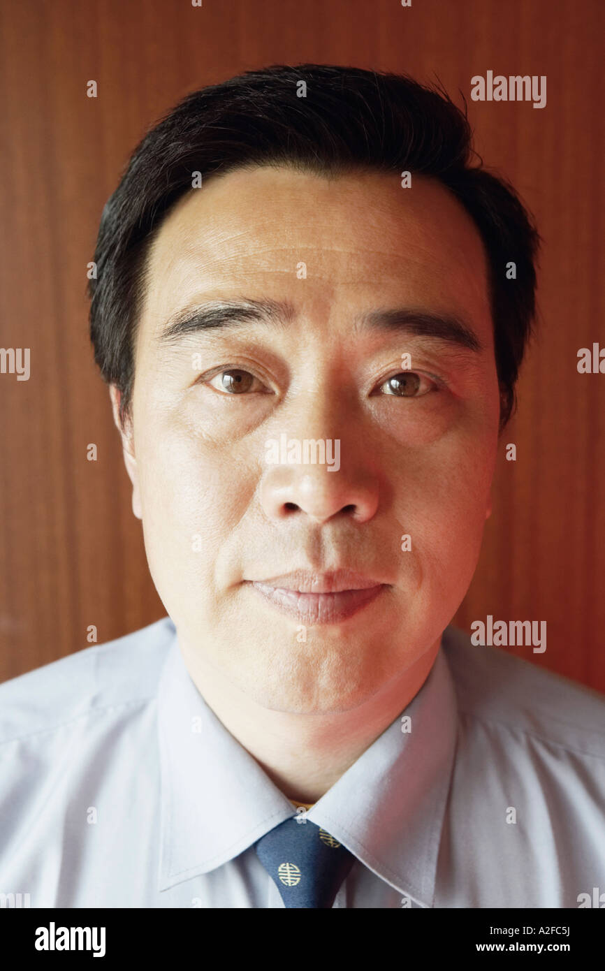Portrait of a businessman looking serious Stock Photo - Alamy