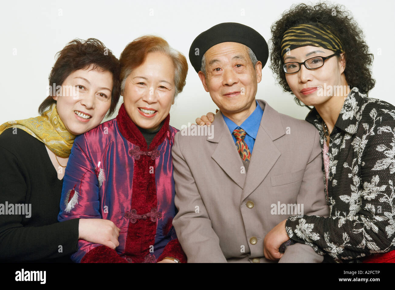 Portrait of a senior man sitting with three mature women Stock Photo ...
