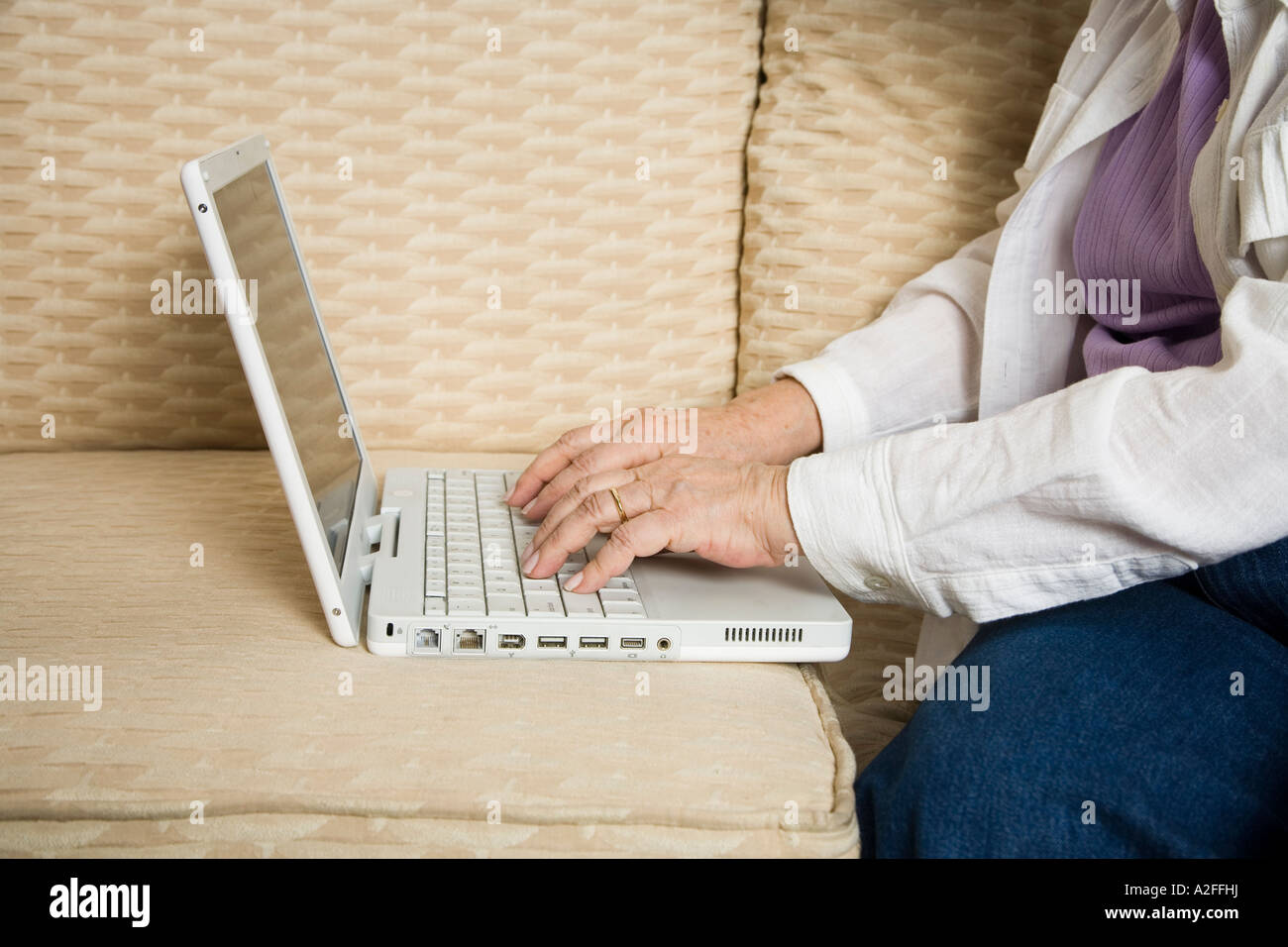 Woman uses laptop computer on couch Stock Photo - Alamy