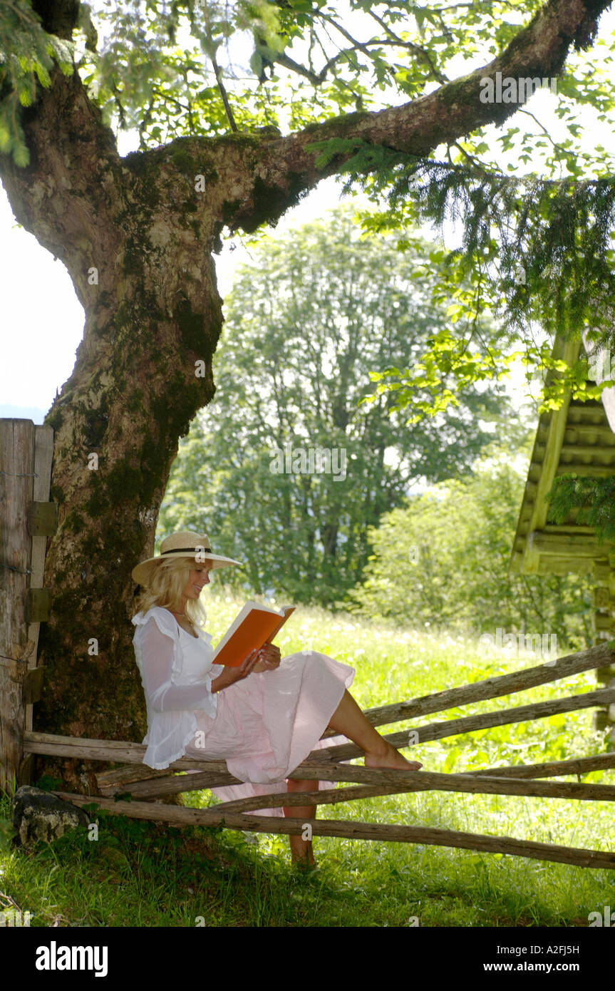 Young woman relaxing under tree reading book Stock Photo - Alamy Young woman relaxing under tree reading book Stock Photo - Alamy