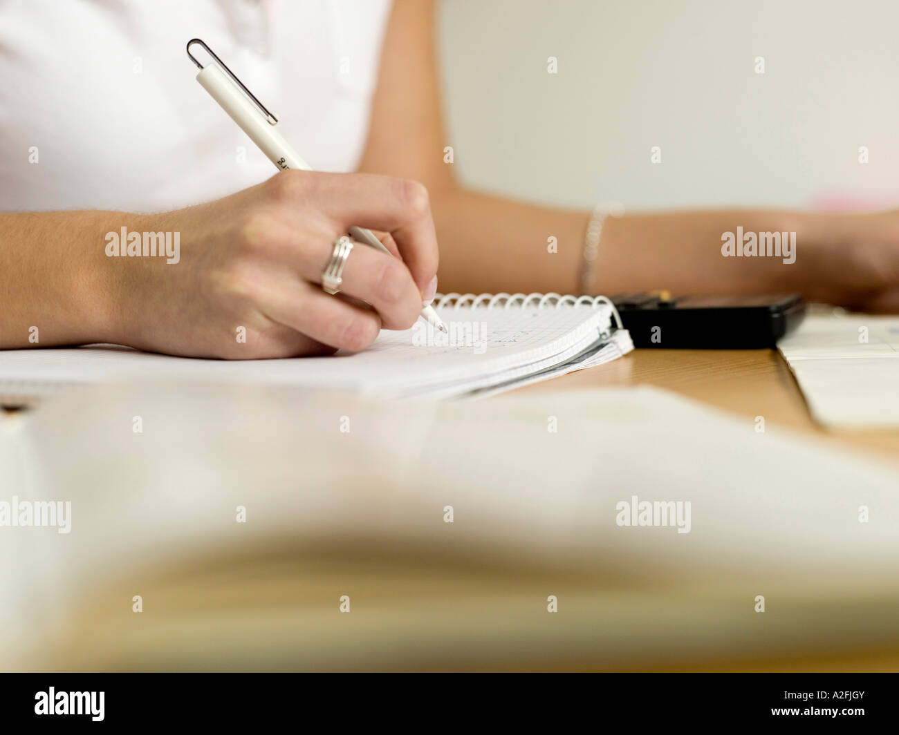 Teenage girl (16-17) writing, focus on hand, close-up Stock Photo - Alamy