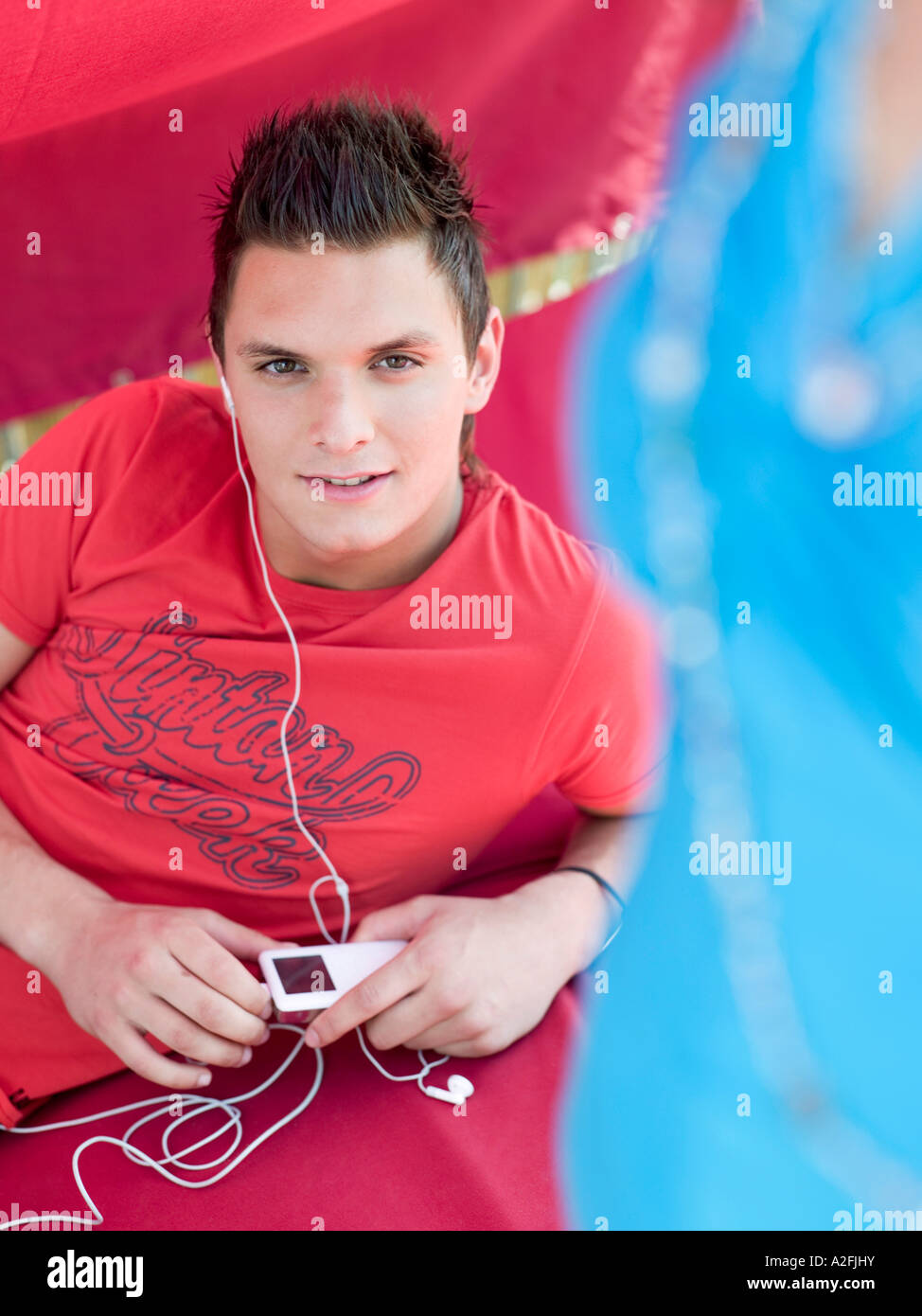 Young man listening to MP3 player, portrait Stock Photo - Alamy