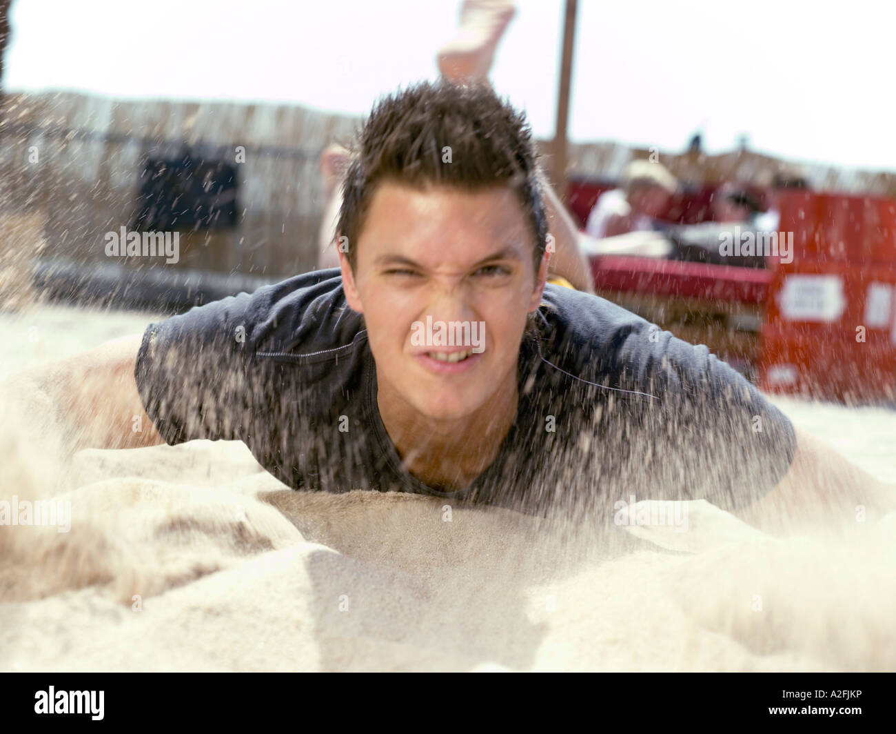 Young man throwing sand, blurred motion Stock Photo - Alamy