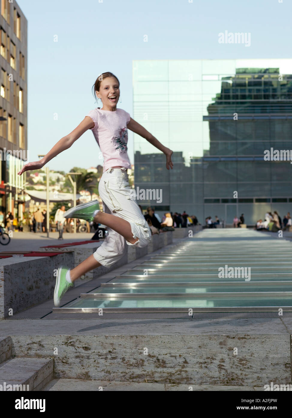 Teenage girl (16-17) jumping, side view Stock Photo - Alamy