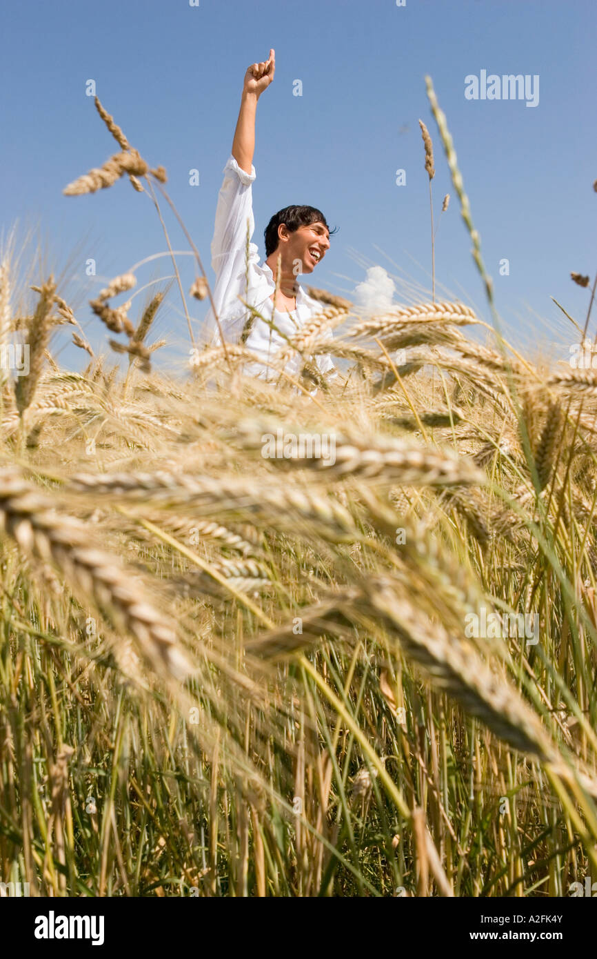 Young man standing in cornfield, one arm outstretched Stock Photo - Alamy