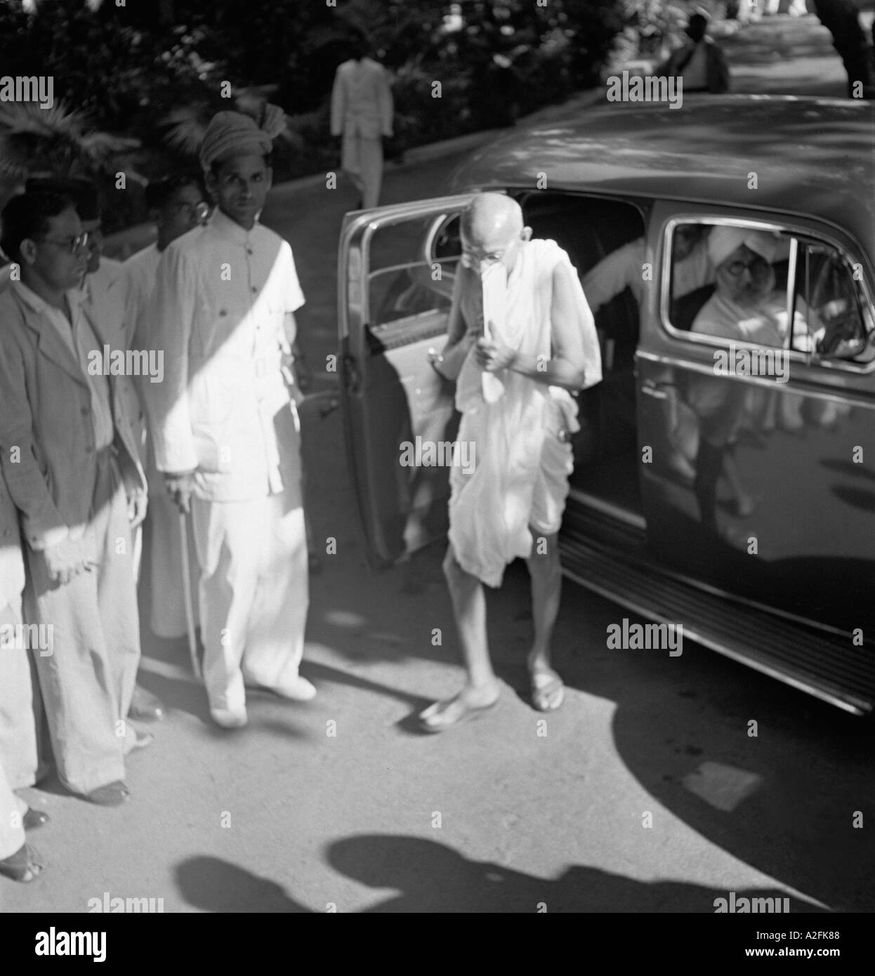 Mahatma Gandhi leaving a car getting out of automobile for his talk ...