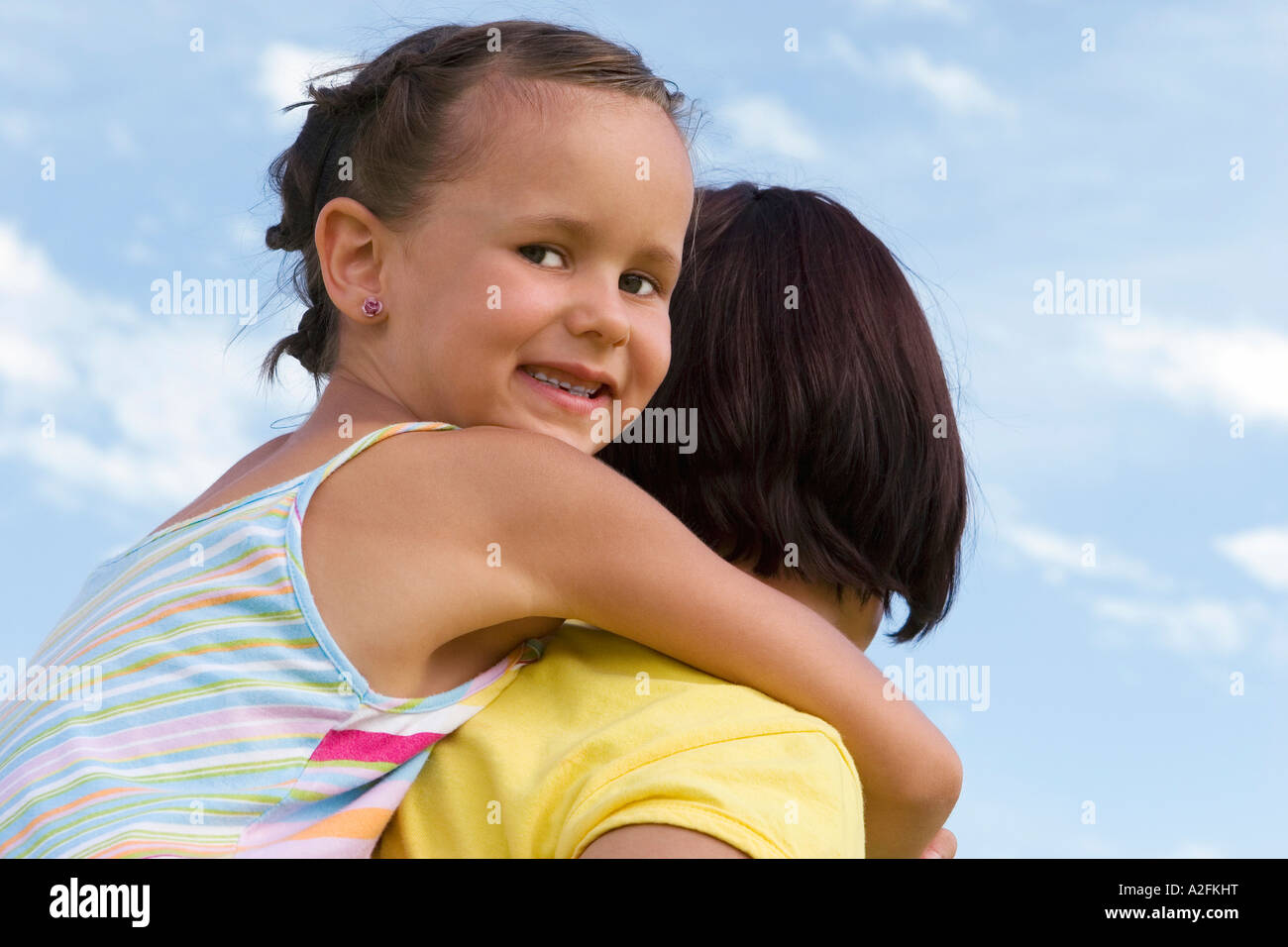 Mother carrying daughter on back, portrait Stock Photo - Alamy