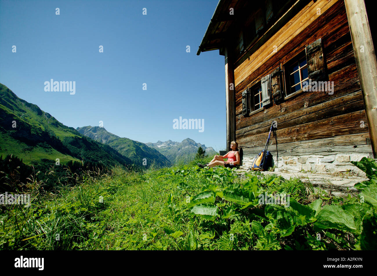 Woman resting at alp cottage Stock Photo - Alamy