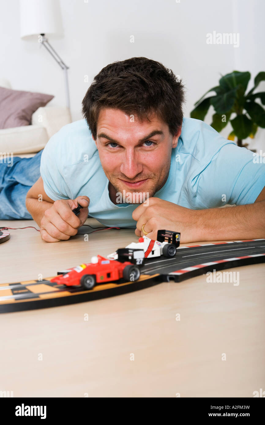 Man playing with toy cars Stock Photo - Alamy