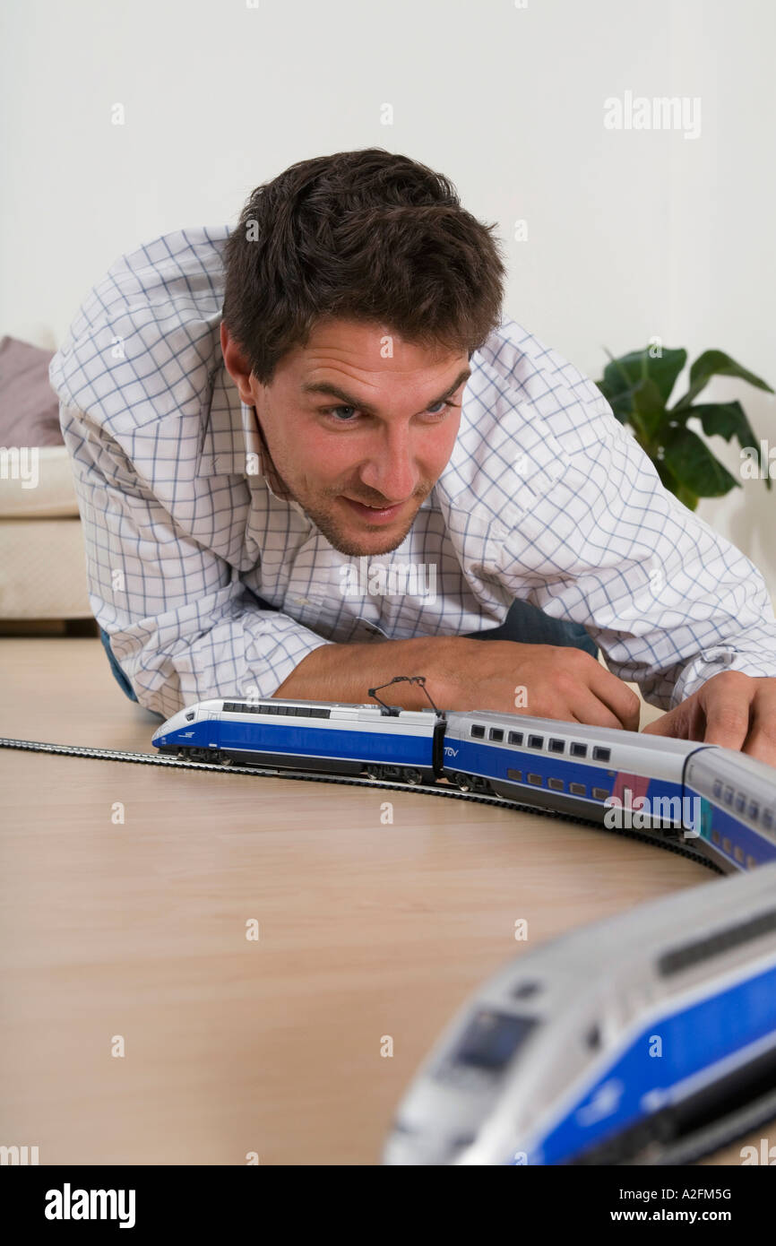 Man playing with toy train Stock Photo - Alamy