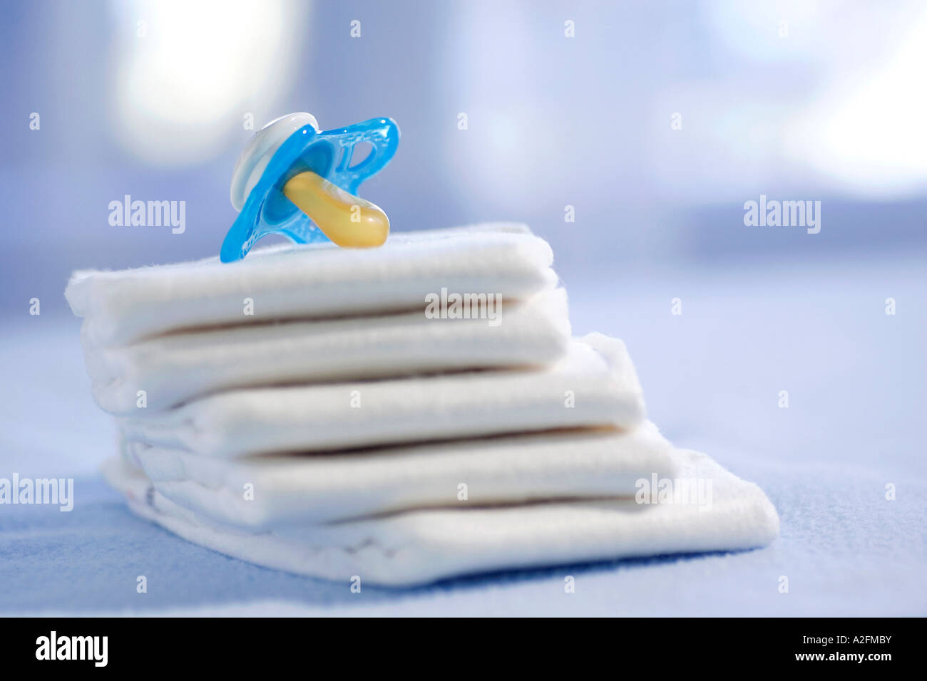 Stacked diapers, pacifier on top Stock Photo - Alamy