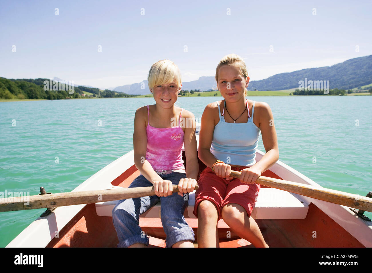 Teenage girls (13-15) rowing boat, smiling, portrait Stock Photo - Alamy