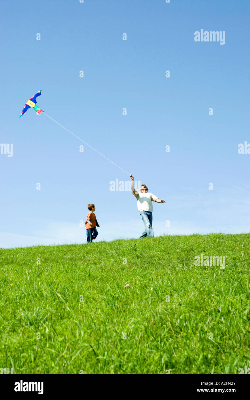 Father and son flying a kite Stock Photo - Alamy