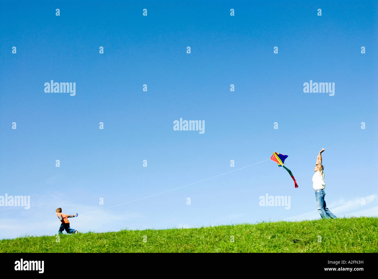 Father and son (4-7) flying kite in park, side view Stock Photo - Alamy