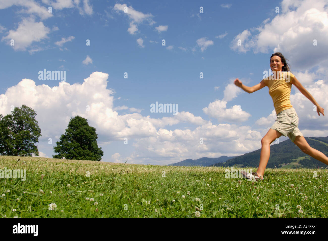 Young woman running, arms outstretched Stock Photo - Alamy