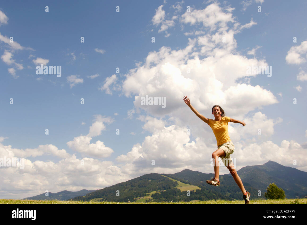 Young woman running, arms outstretched Stock Photo - Alamy
