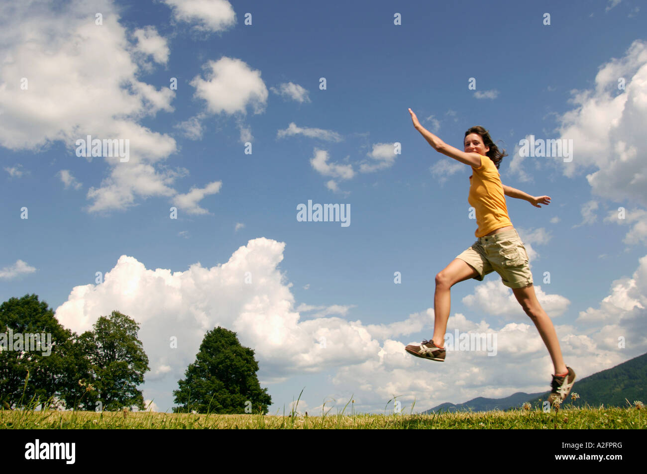 Young woman running, arms outstretched Stock Photo - Alamy