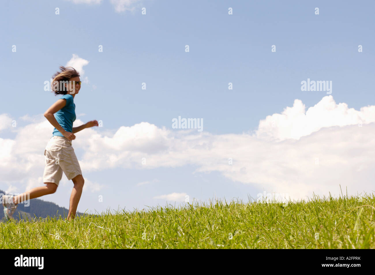 Young woman jogging, side view Stock Photo - Alamy