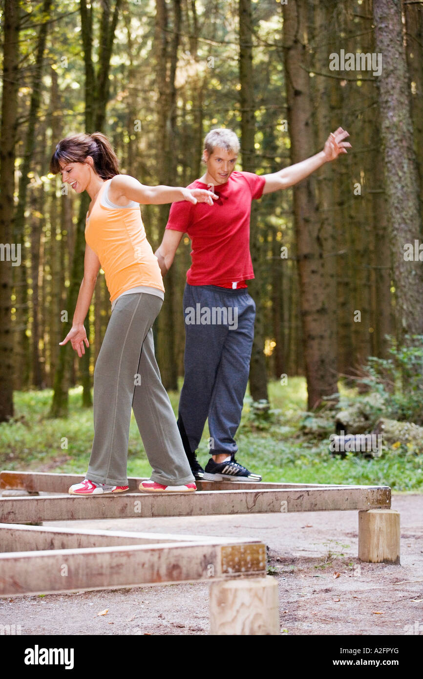 Young couple balancing on bars Stock Photo - Alamy
