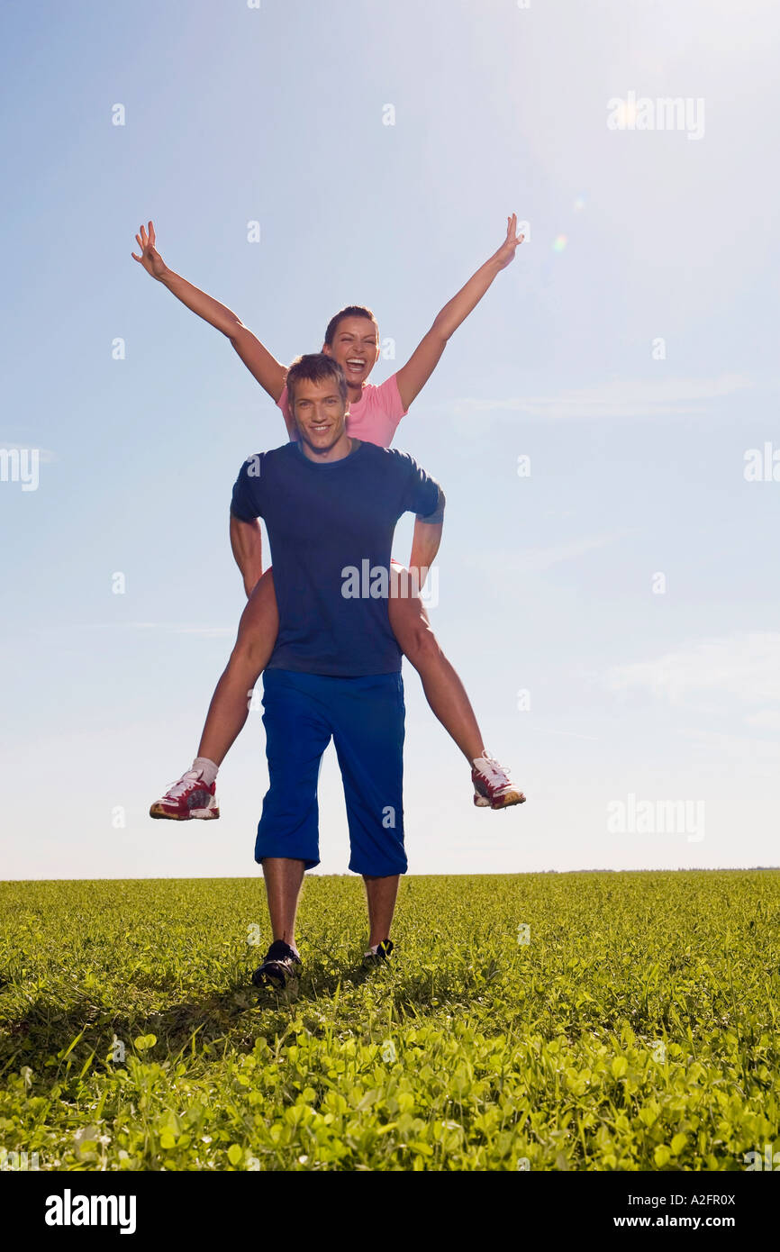 Young man carrying woman on back Stock Photo - Alamy