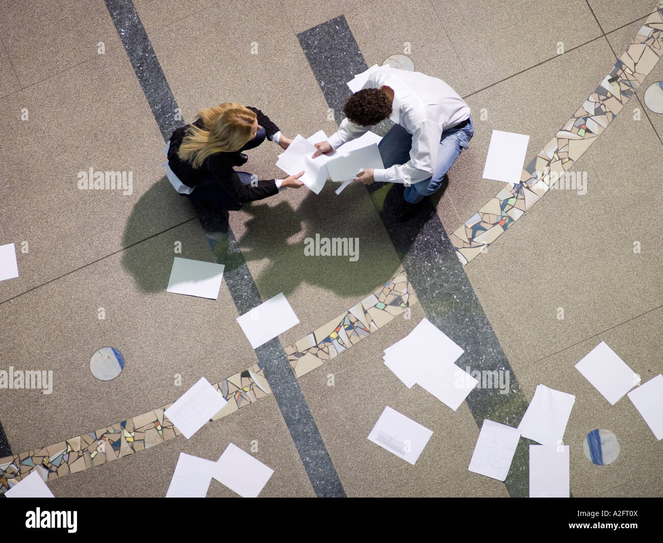 Couple in hall collecting papers, elevated view Stock Photo - Alamy
