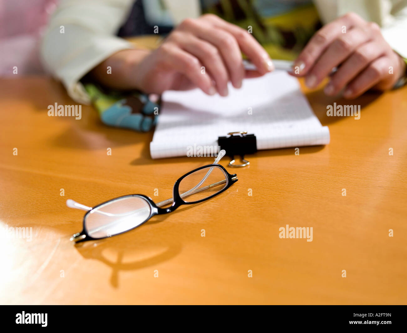 Spectacles lying on desk Stock Photo - Alamy