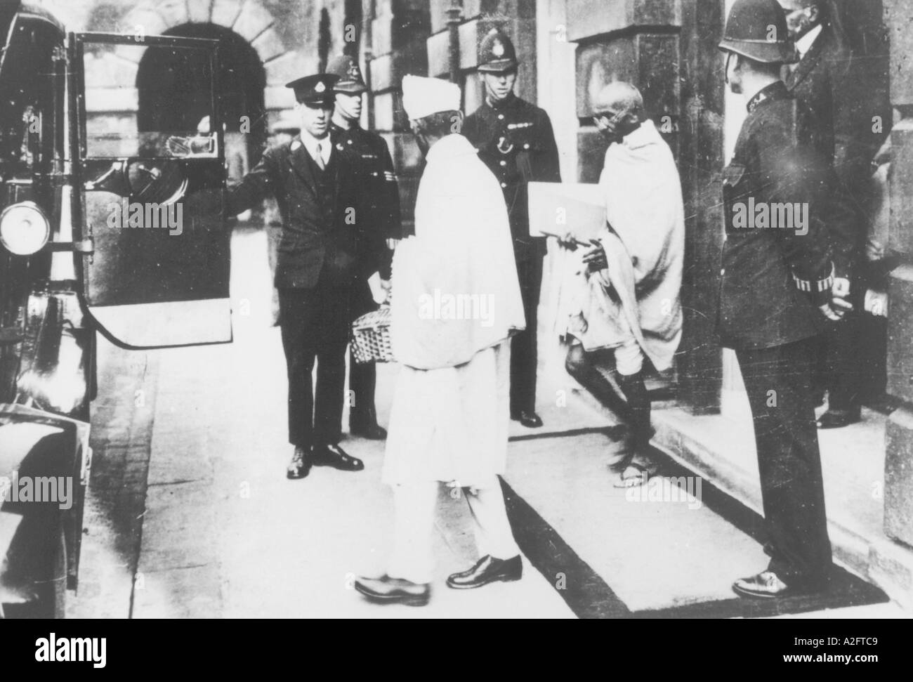 Mahatma Gandhi walking leaving a building at London England UK Britain ...