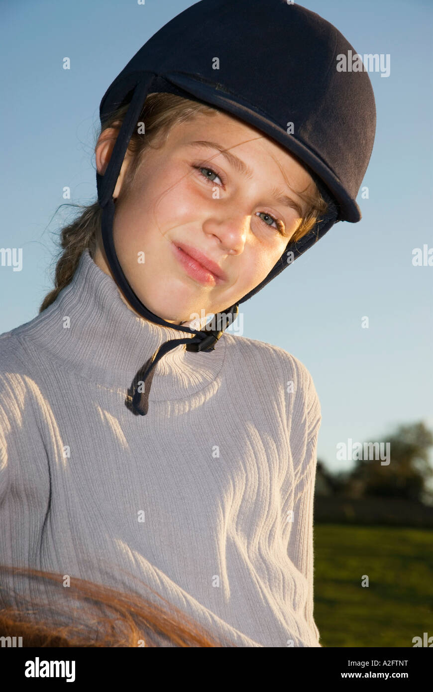 Girl wearing riding helmet Stock Photo - Alamy