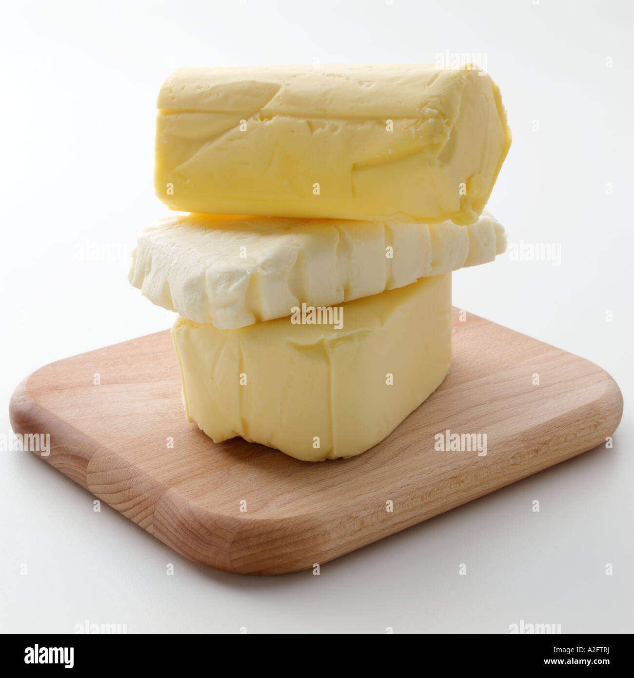 A stack of butter pats on a white background Stock Photo - Alamy