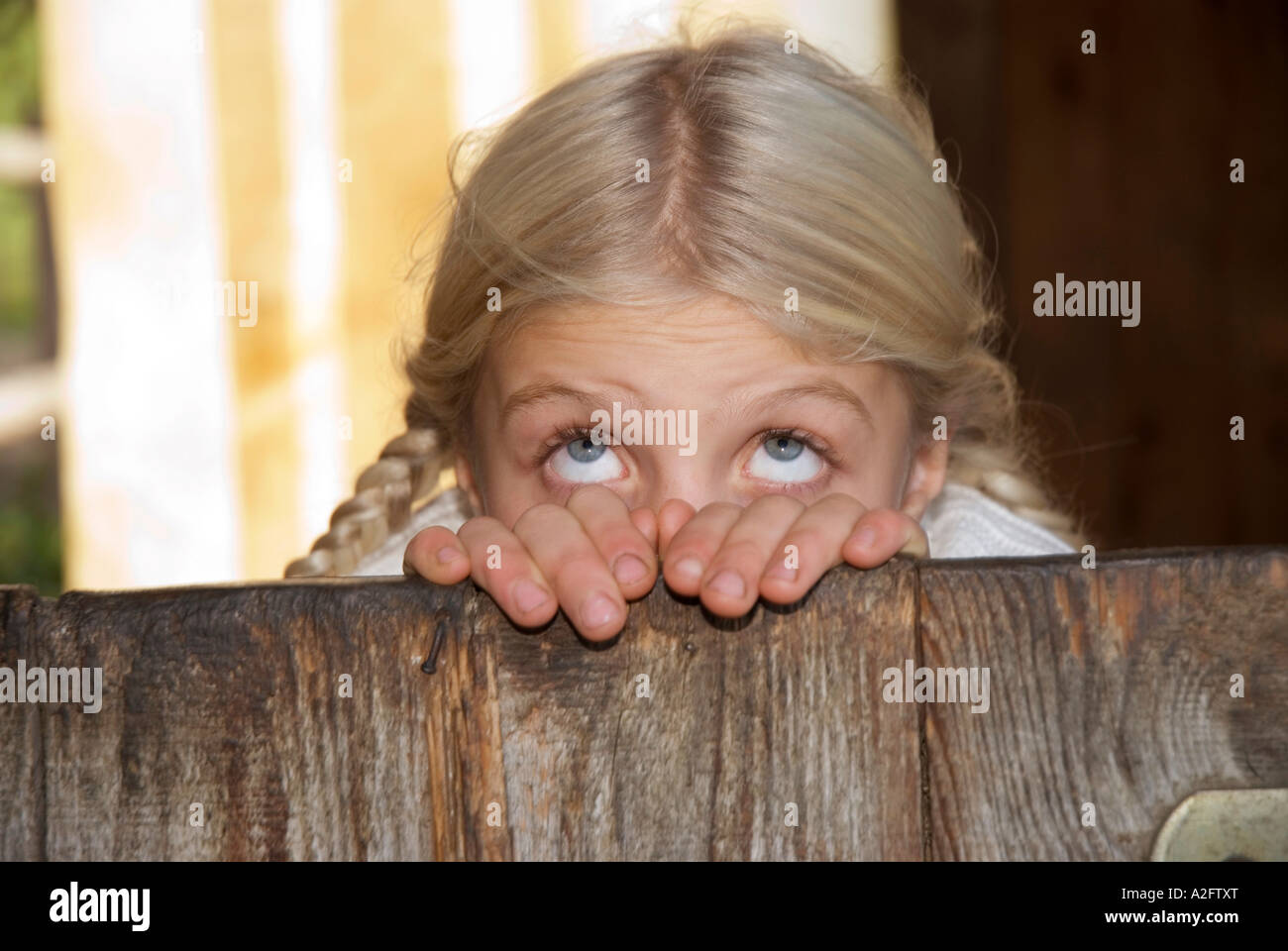 Girl (7-9) in barn, rolling eyes, close-up Stock Photo - Alamy