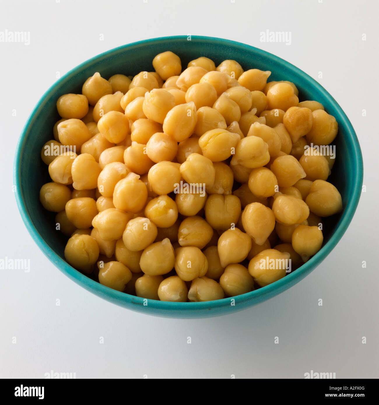 A bowl of chickpeas on a white background Stock Photo - Alamy